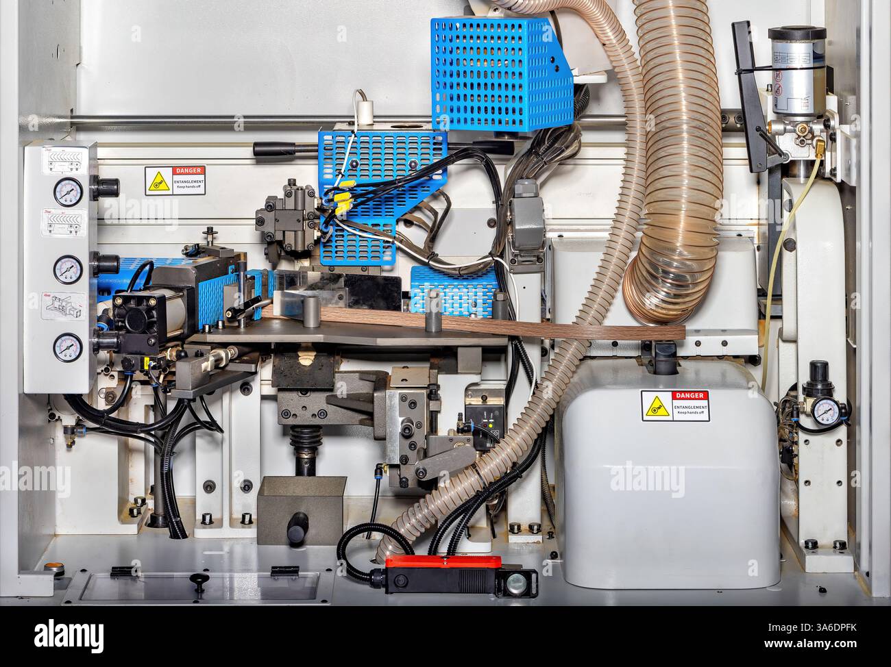 This advanced woodworking machine operates in a busy workshop, shaping ...