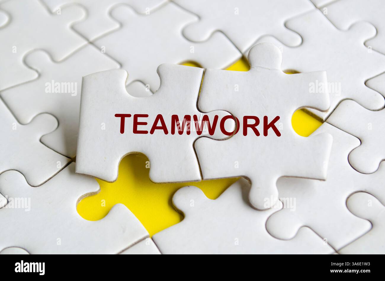 Teamwork text on missing jigsaw puzzle. Unity and One Team concept ...