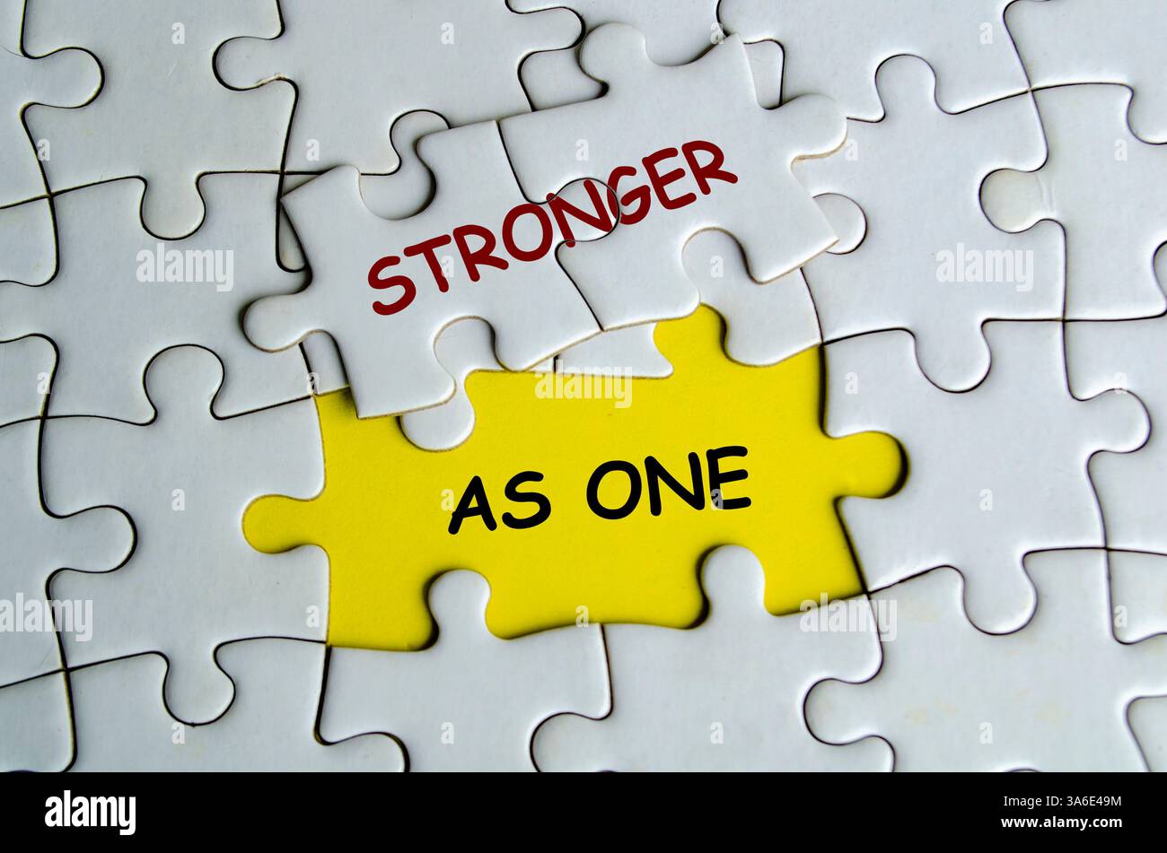 Stronger As One text on missing jigsaw puzzle. One Team and Unity ...