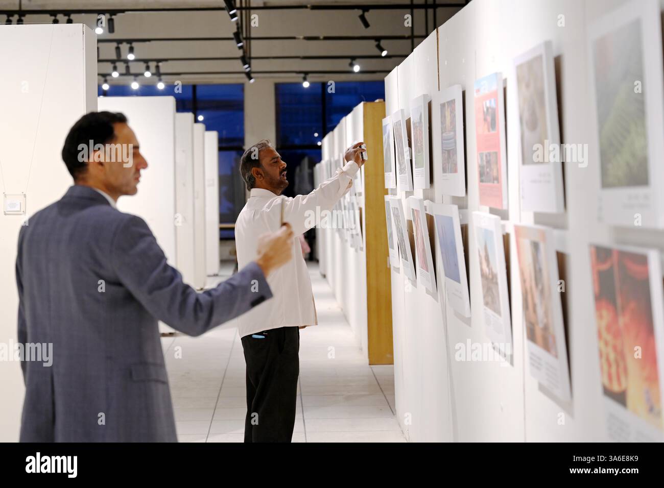 Islambad, Pakistan. 23rd Mar, 2025. Visitors view paintings by Chinese ...