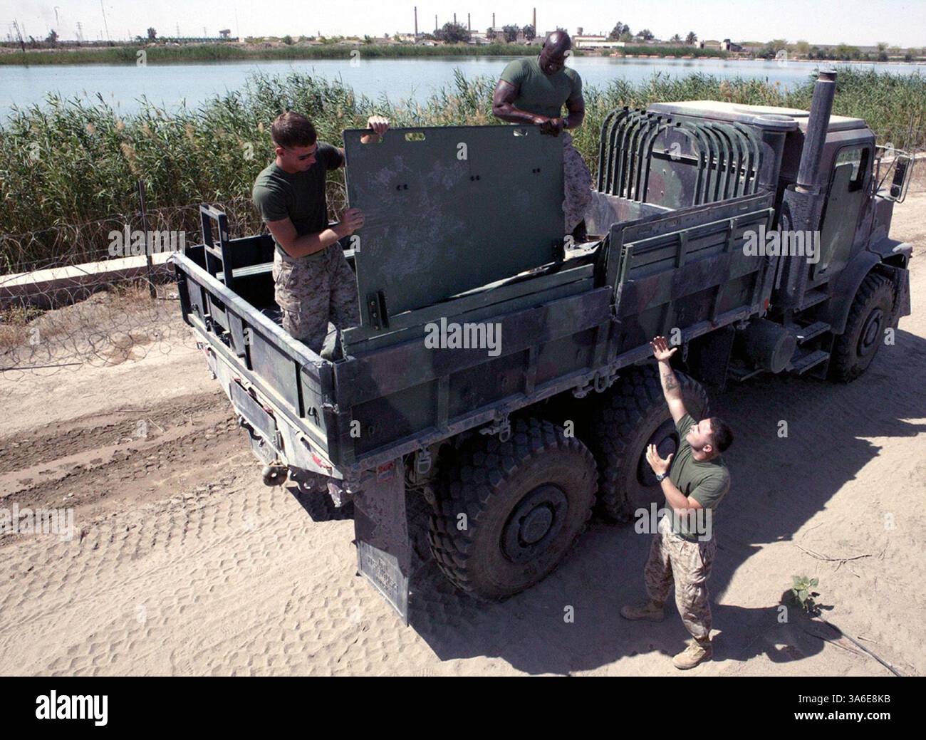 May 07, 2004; Ar Ramadi, Iraq; Cpl. ADAM M. YOUNGMAN (far right), motor ...