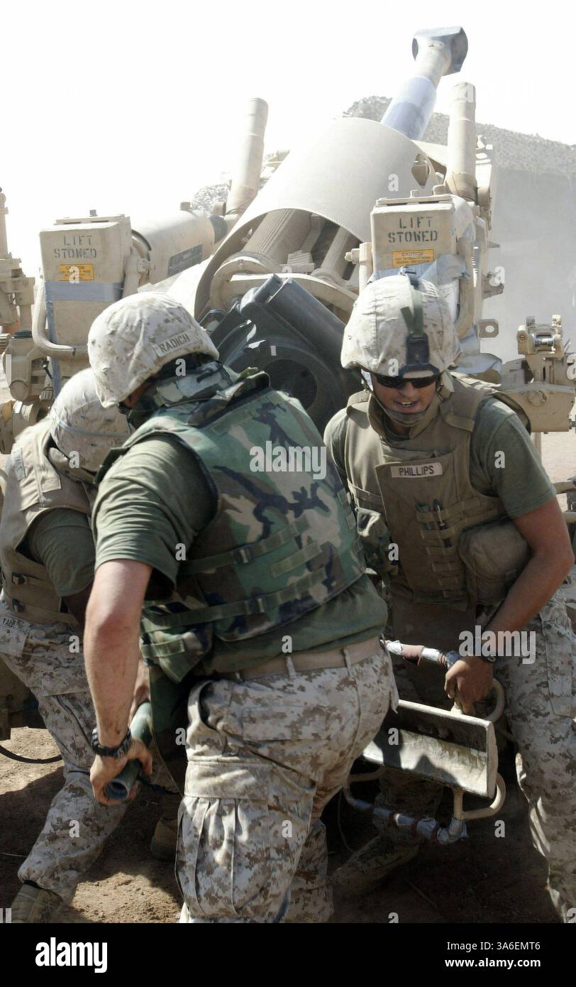 Oct 10, 2004; Camp Fallujah, Iraq; The Marines of gun five work quickly ...