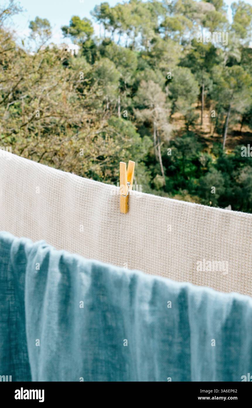Linens air drying on clothesline outdoors with forest background Stock ...