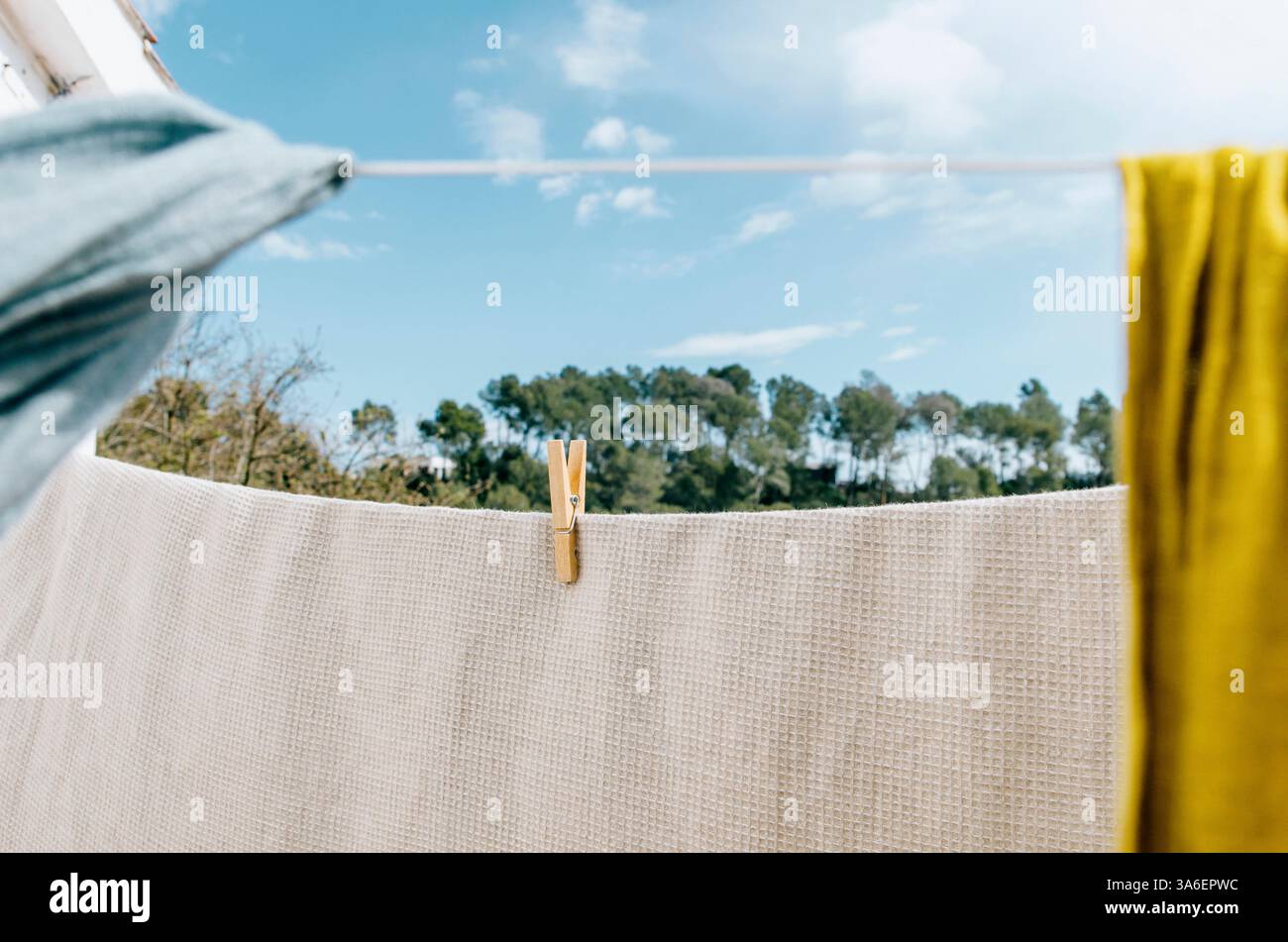 Linen scarves and towel air drying on clothesline Stock Photo - Alamy