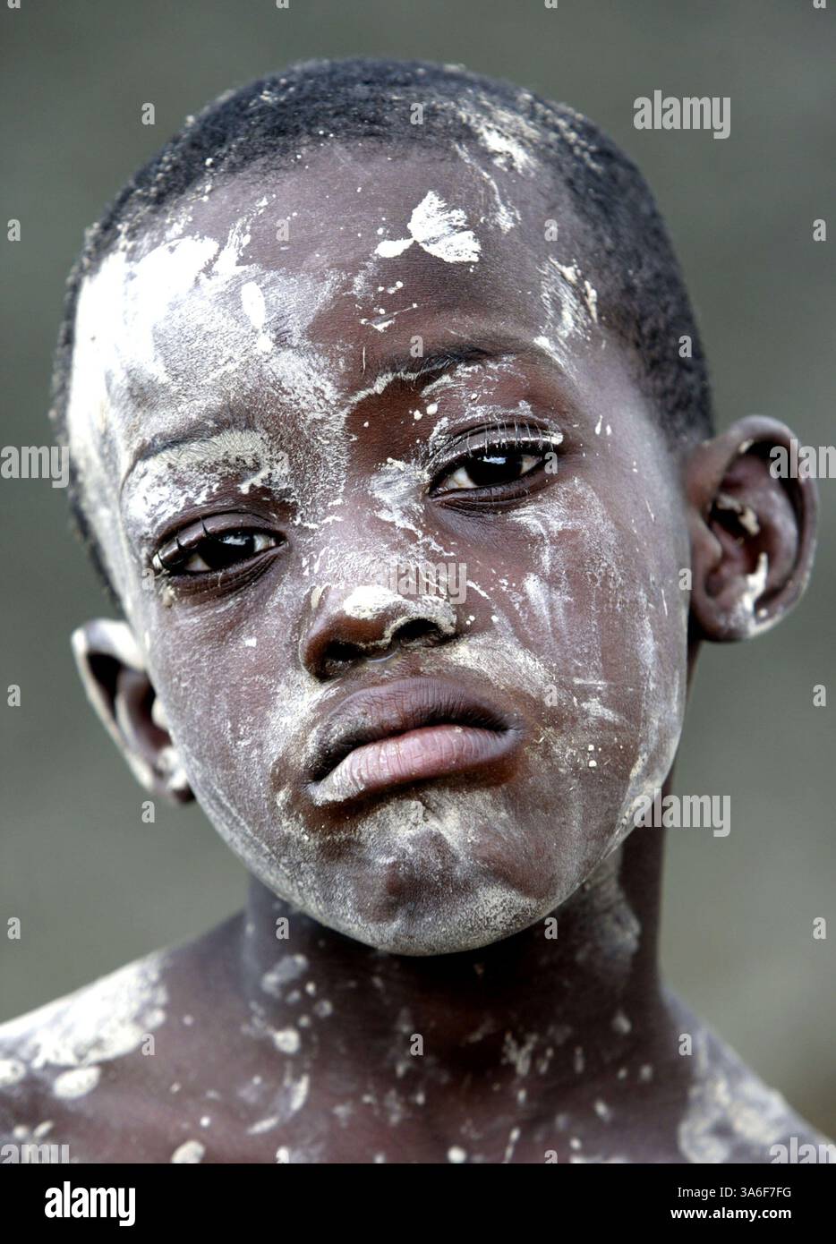 Sept. 4, 2008 - Sonson Pierre, 7, sits knee-deep in mud outside his ...