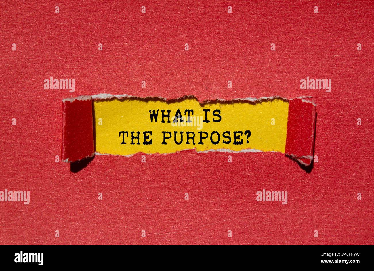 What is the purpose message written on ripped torn red paper on yellow background. Conceptual ...