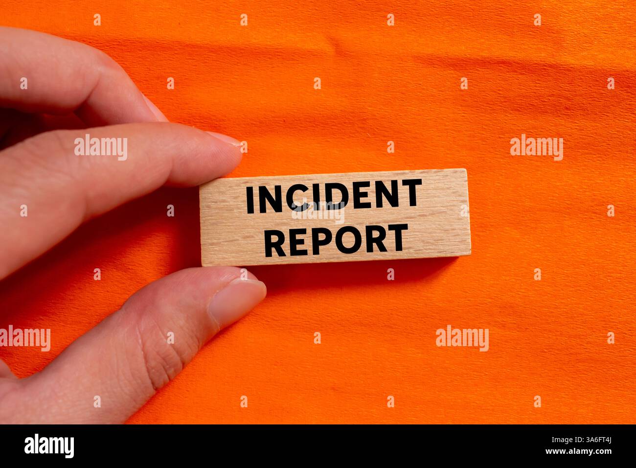 Incident report message written on wooden block on orange background ...