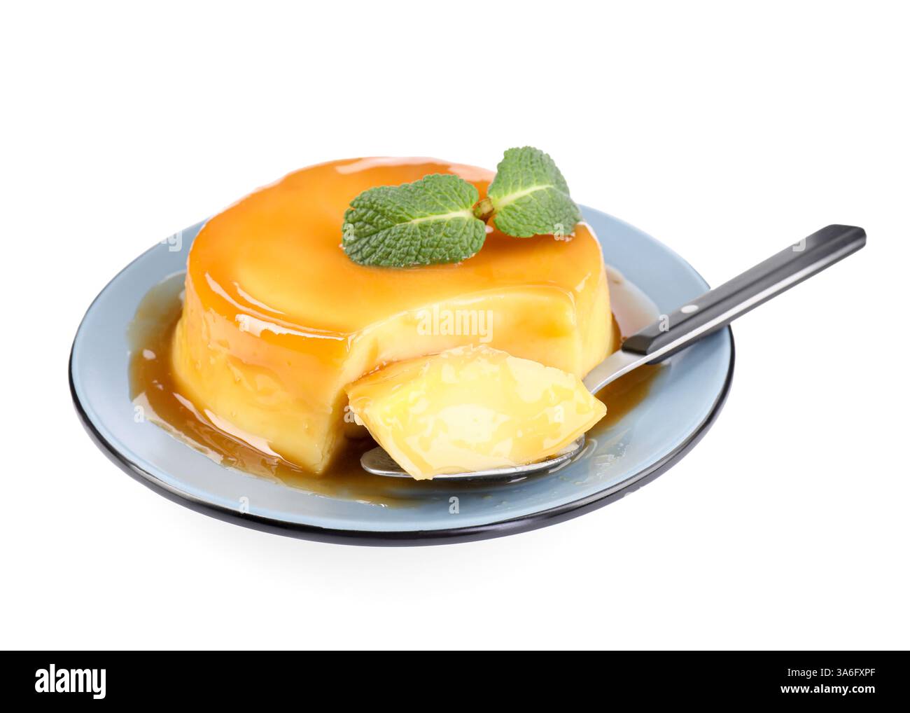 Delicious pudding with caramel sauce, mint and spoon isolated on white ...