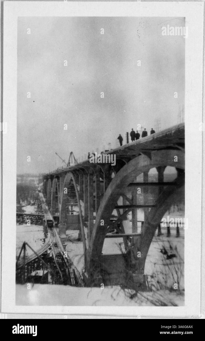 Men stand atop the under-construction Mendota Bridge, inspecting the ...