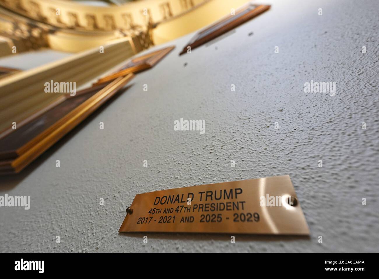 The plaque that marked the placement of a portrait of President Donald ...