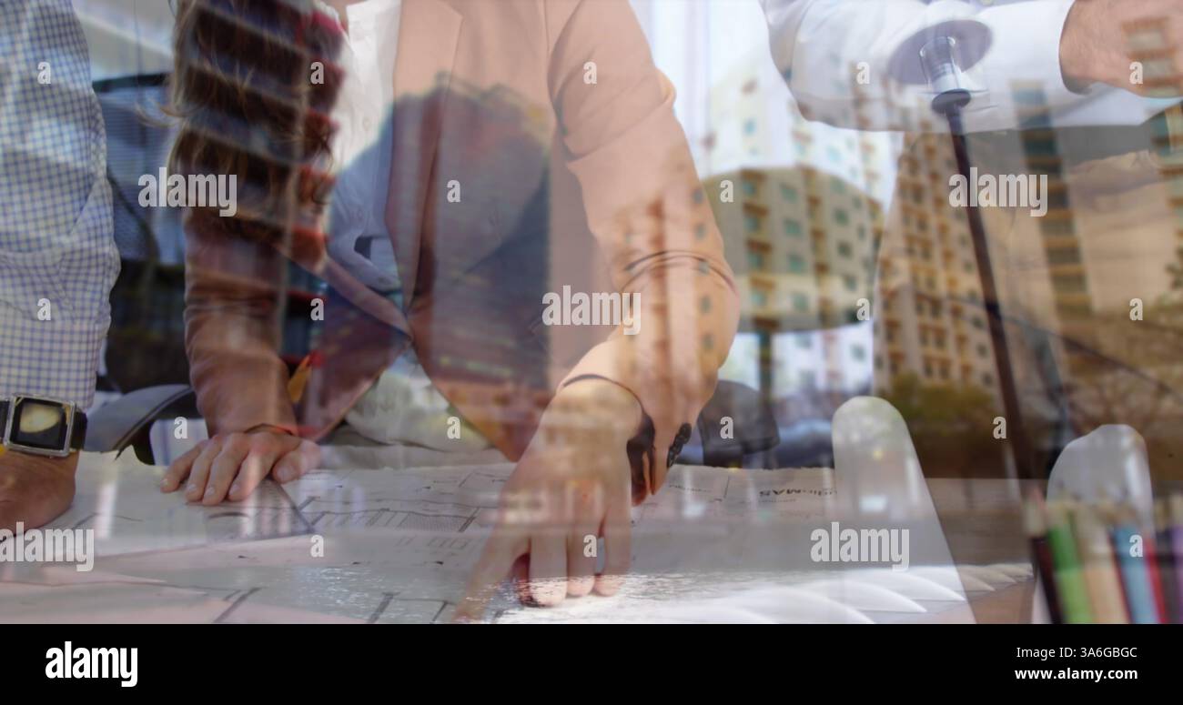 Architects collaborating on blueprints in modern office, planning urban ...