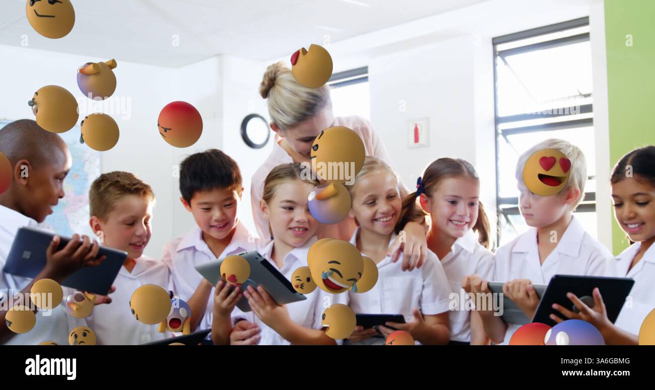 In school, diverse students and teacher using tablets with floating emojis. Education ...