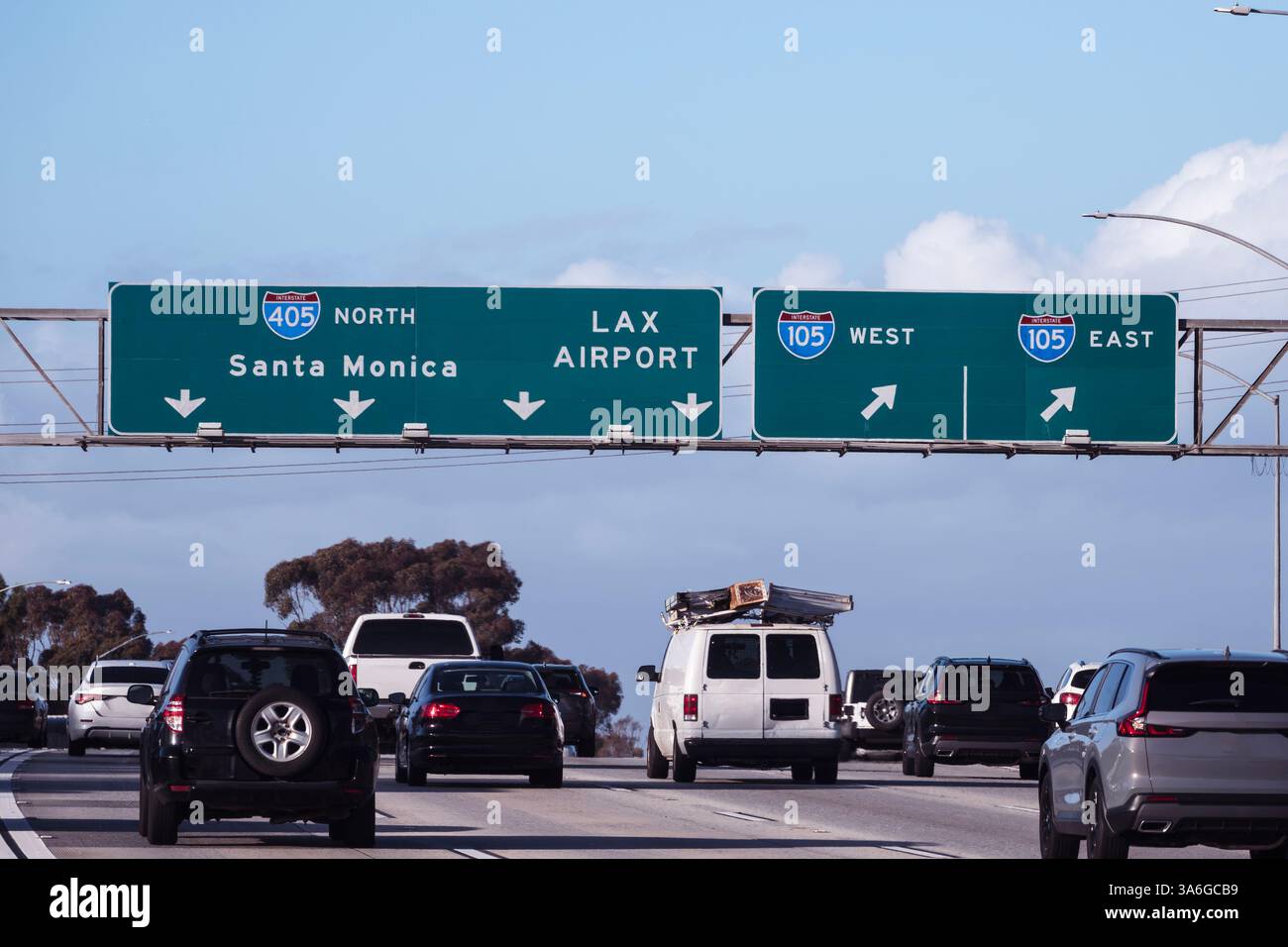 Slow traffic driving below freeway signs on the San Diego 405 freeway ...