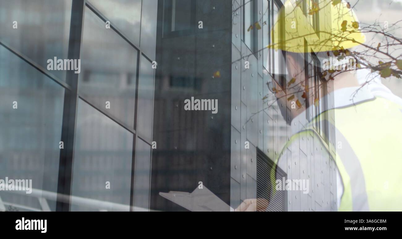 Construction worker in safety vest and helmet inspecting building with ...