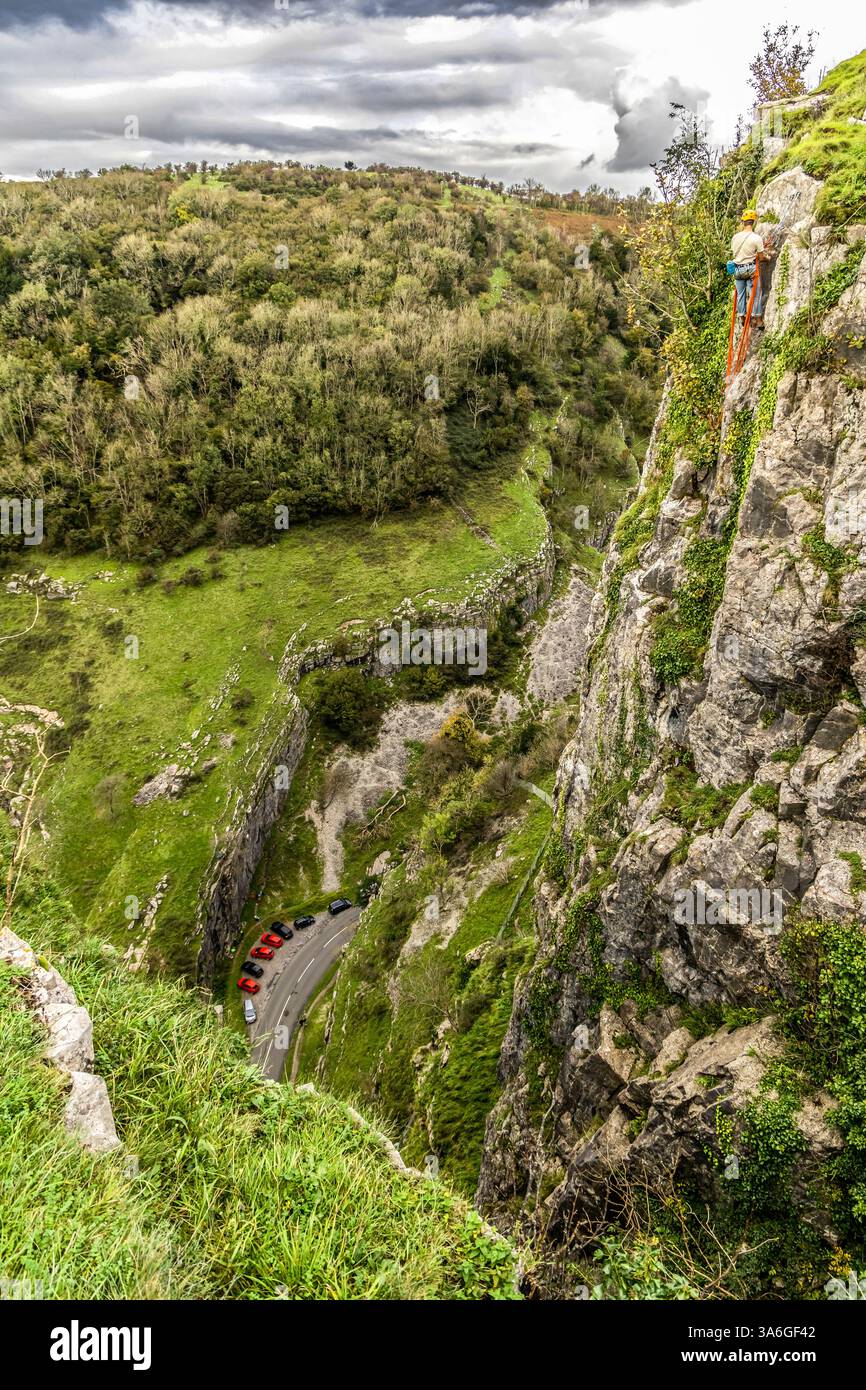 View from cliff edge of Cheddar Gorge and mountain climber in Somerset ...
