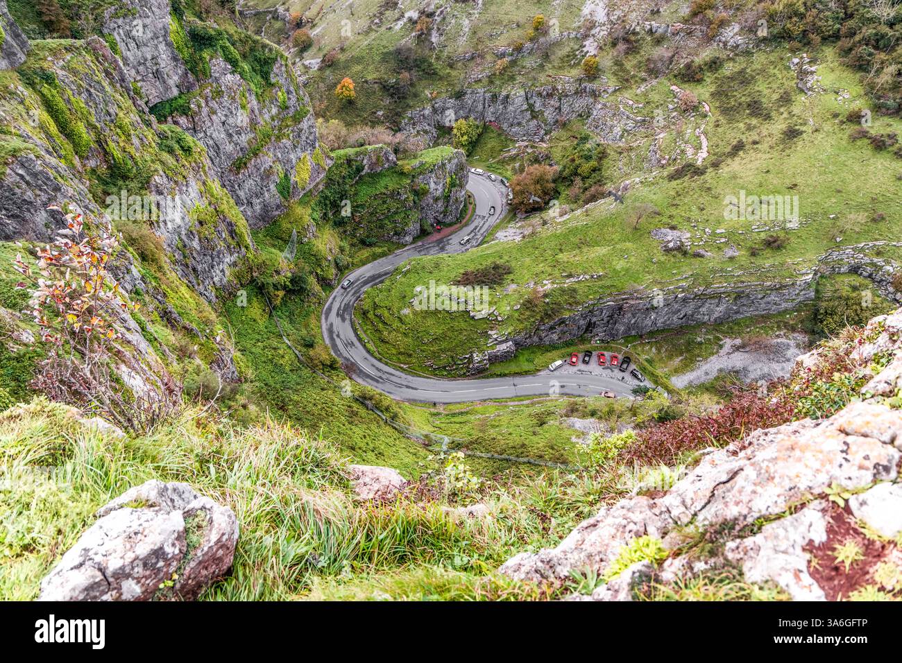 View from above cliff edge of winding road and cars Cheddar Gorge in ...