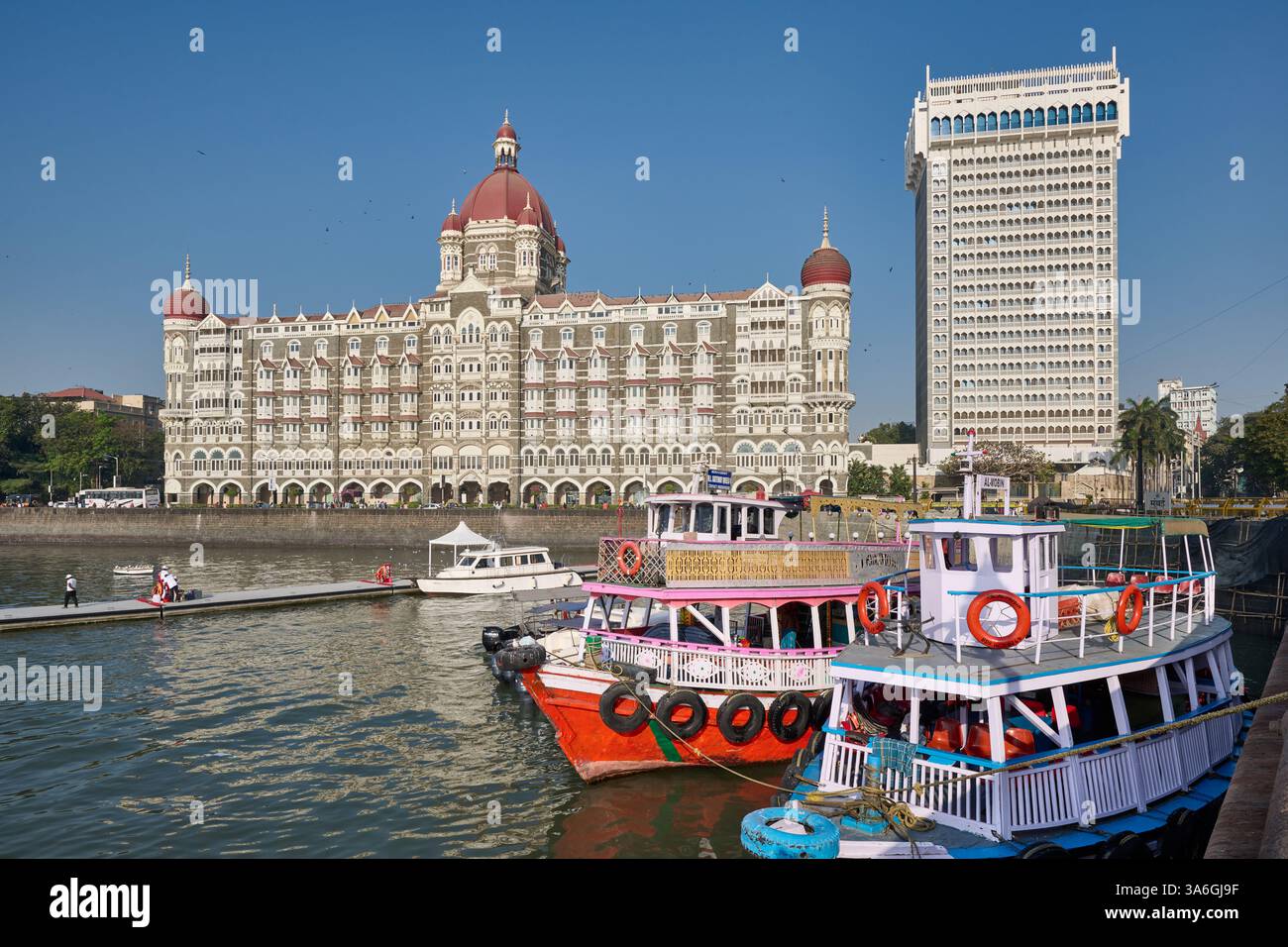 local ships in front of the famous Taj Mahal Palace hotel at the harbour of Mumbai, Bombay ...