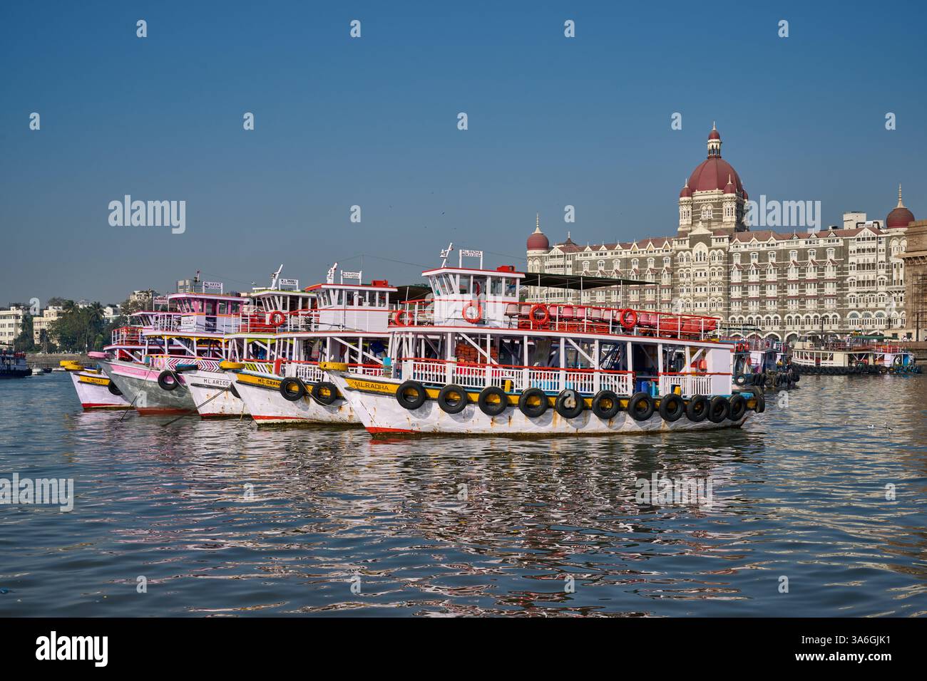 local ships in front of the famous Taj Mahal Palace hotel at the harbour of Mumbai, Bombay ...
