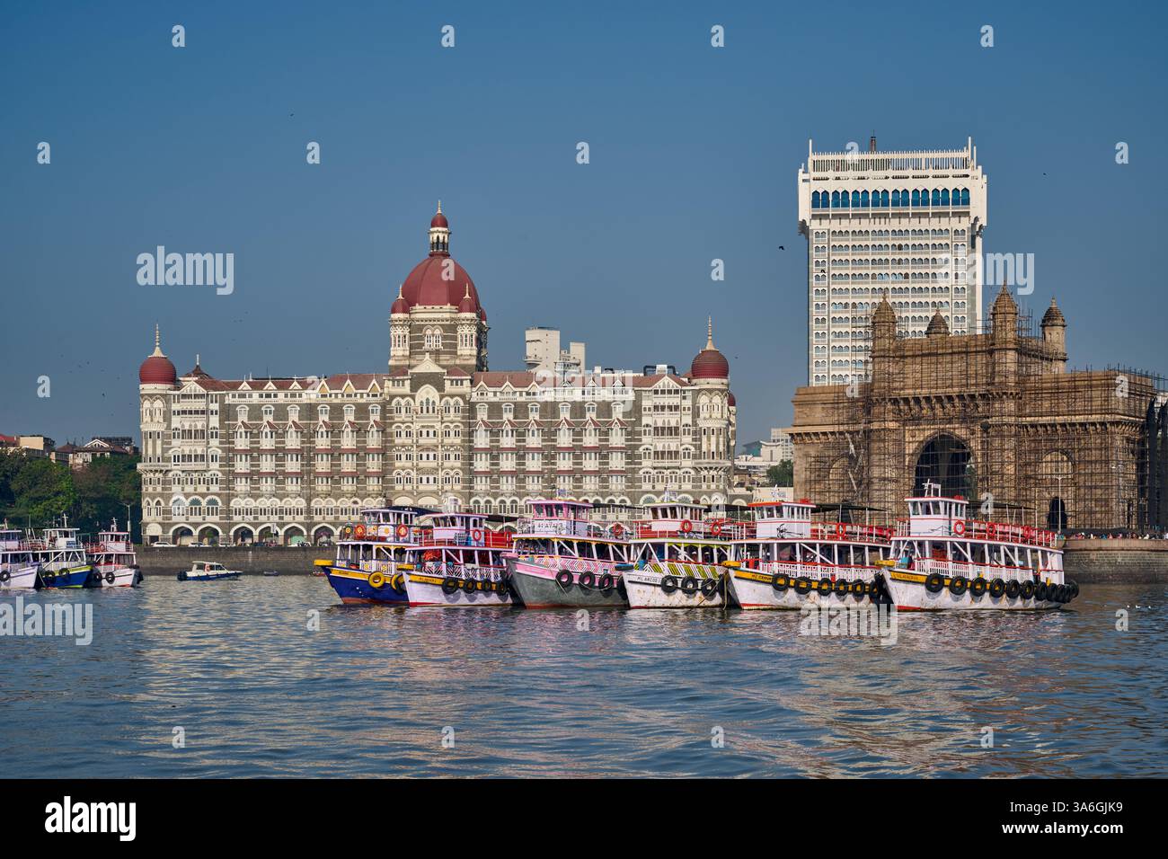local ships in front of the famous Taj Mahal Palace hotel at the harbour of Mumbai, Bombay ...