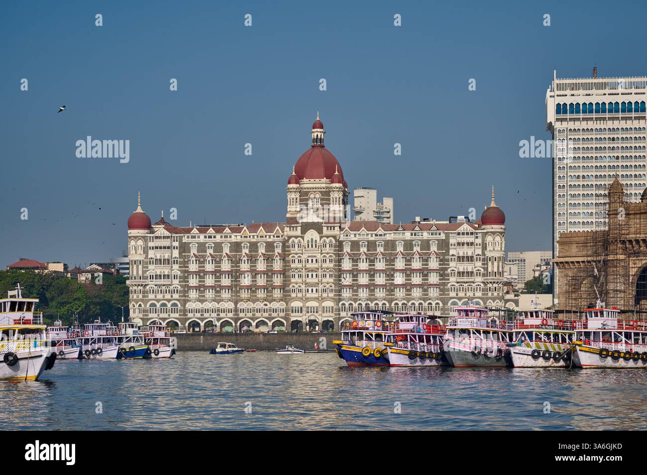 local ships in front of the famous Taj Mahal Palace hotel at the harbour of Mumbai, Bombay ...
