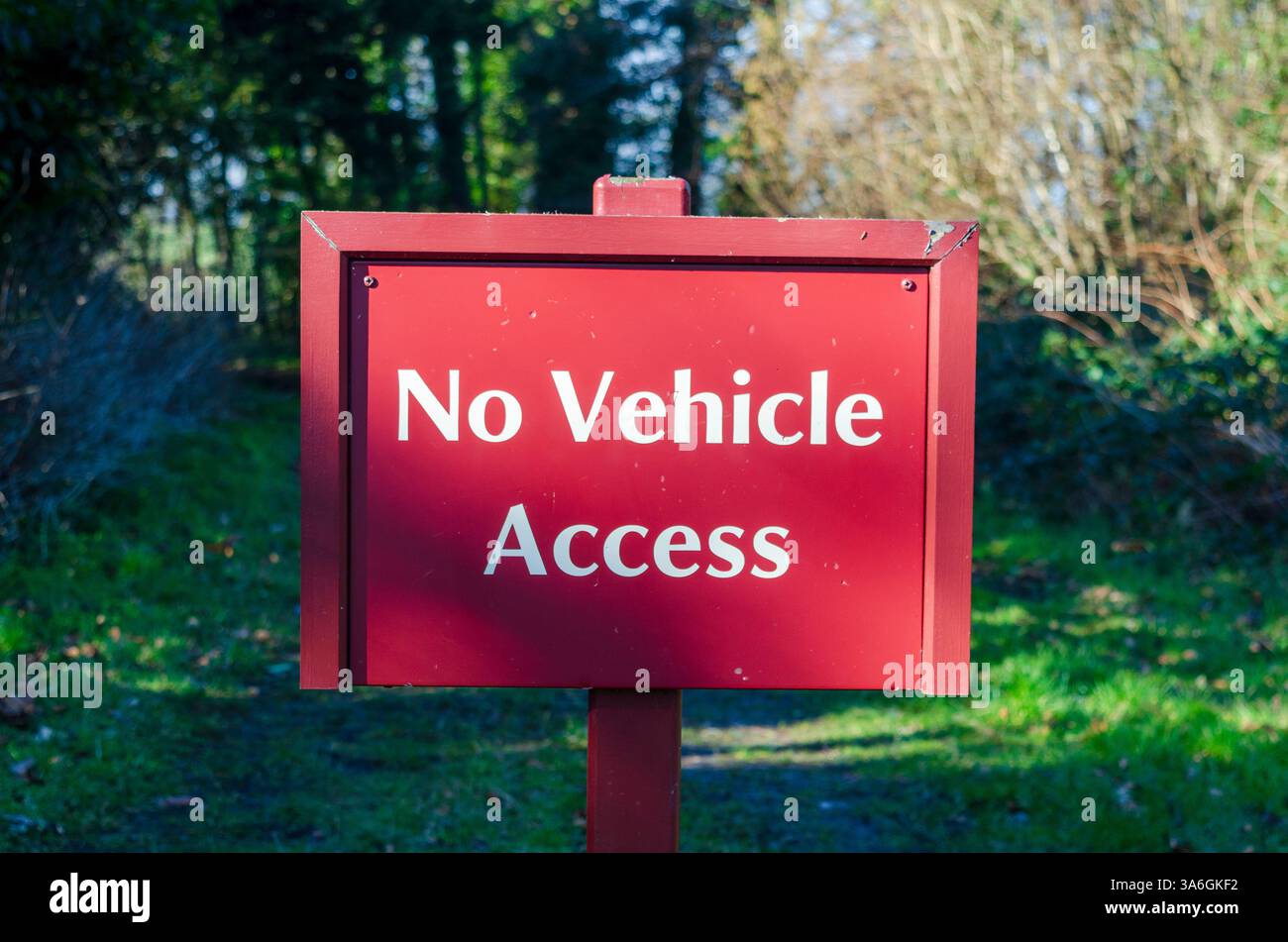 Red sign with white writing saying in a country park 'No vehicle access ...