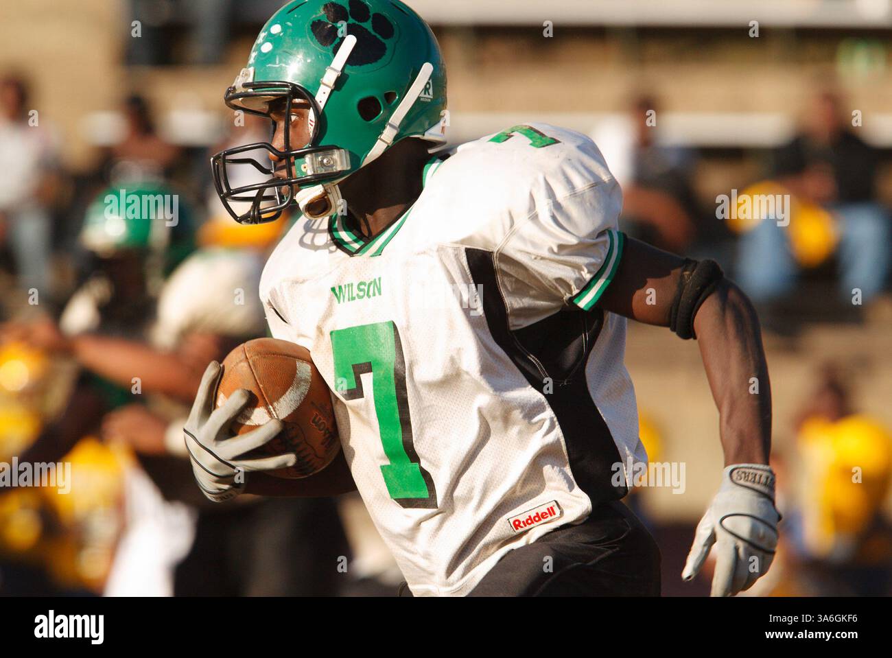 Wide receiver carrying the ball during a football game between Wilson ...