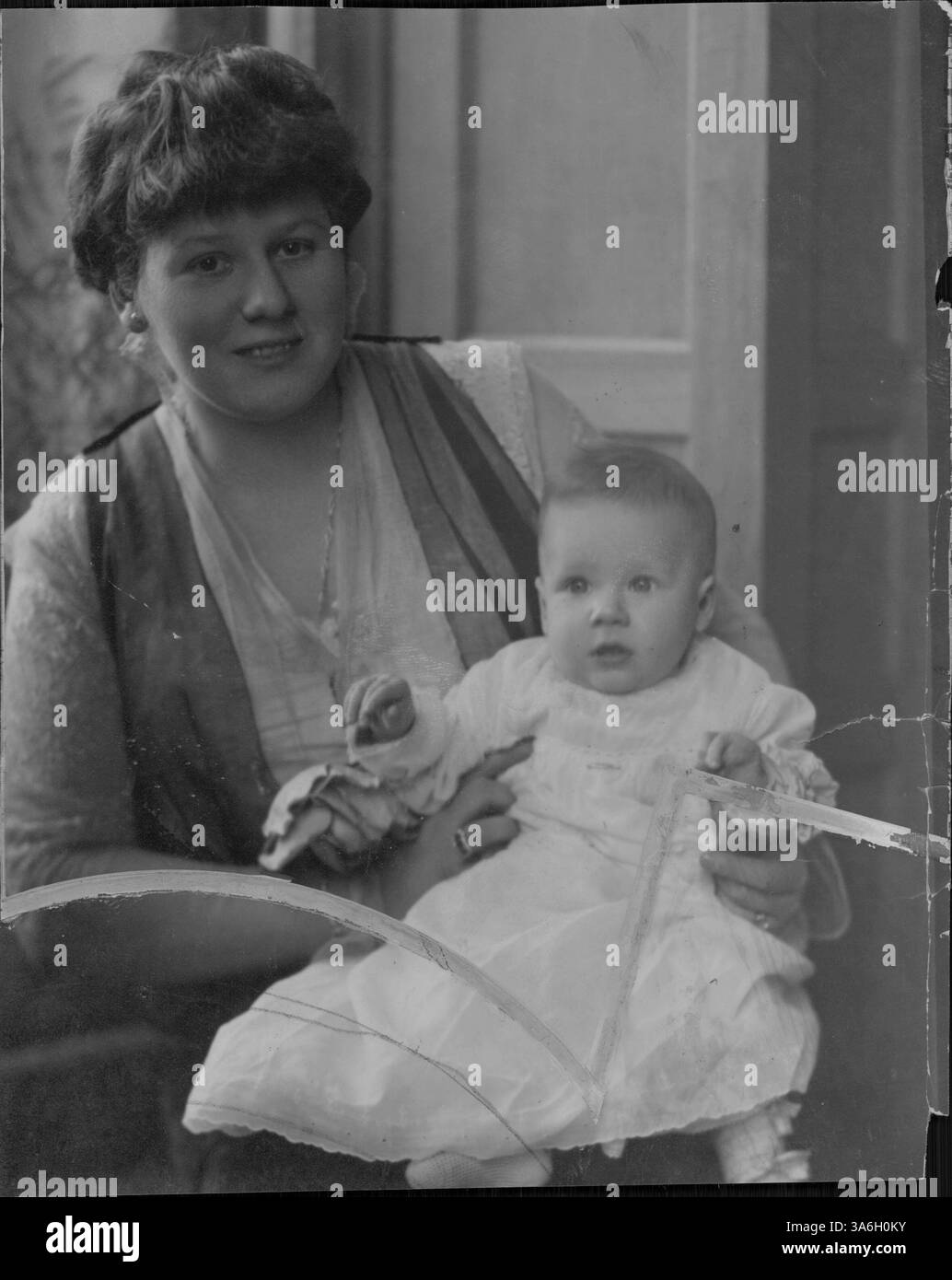 Mrs. L.H. Lucker is pictured holding her daughter, Miriam Pfaff Lucker ...