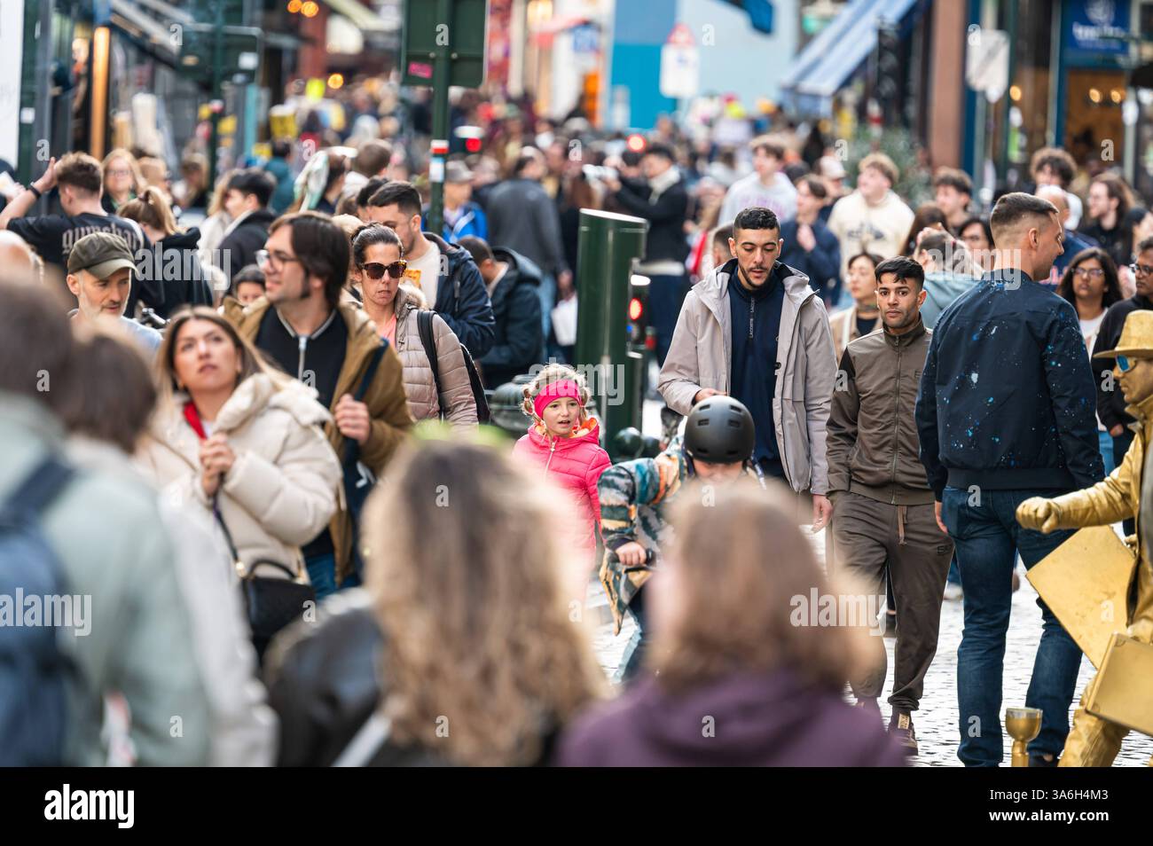 Crowd of tourists walking through the rue au beurre towards the Grand ...