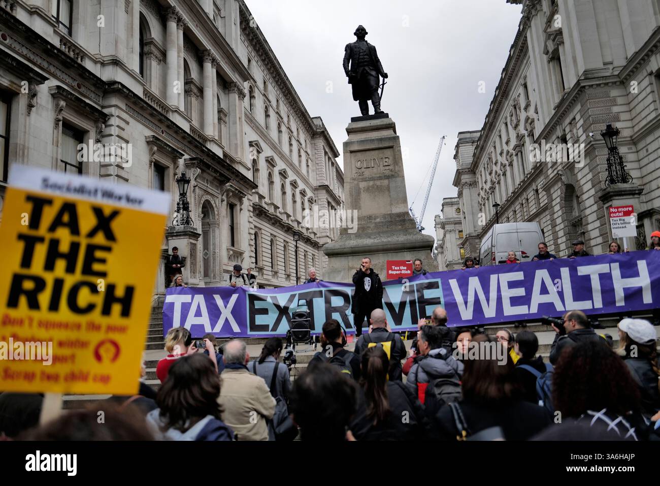 Protesters gather outside the UK Treasury in London for the “Tax the ...