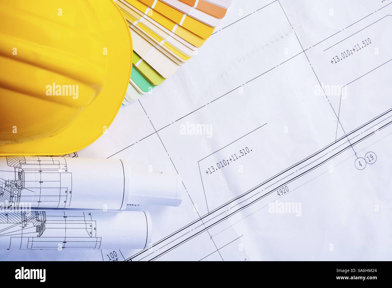 Copyspace background rolled blueprints helmet color palette Stock Photo ...