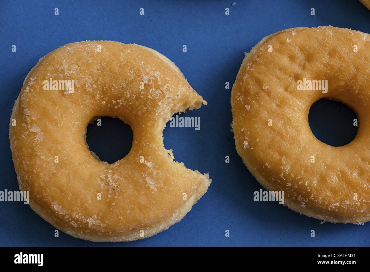 Bitten donut on blue hi-res stock photography and images - Alamy