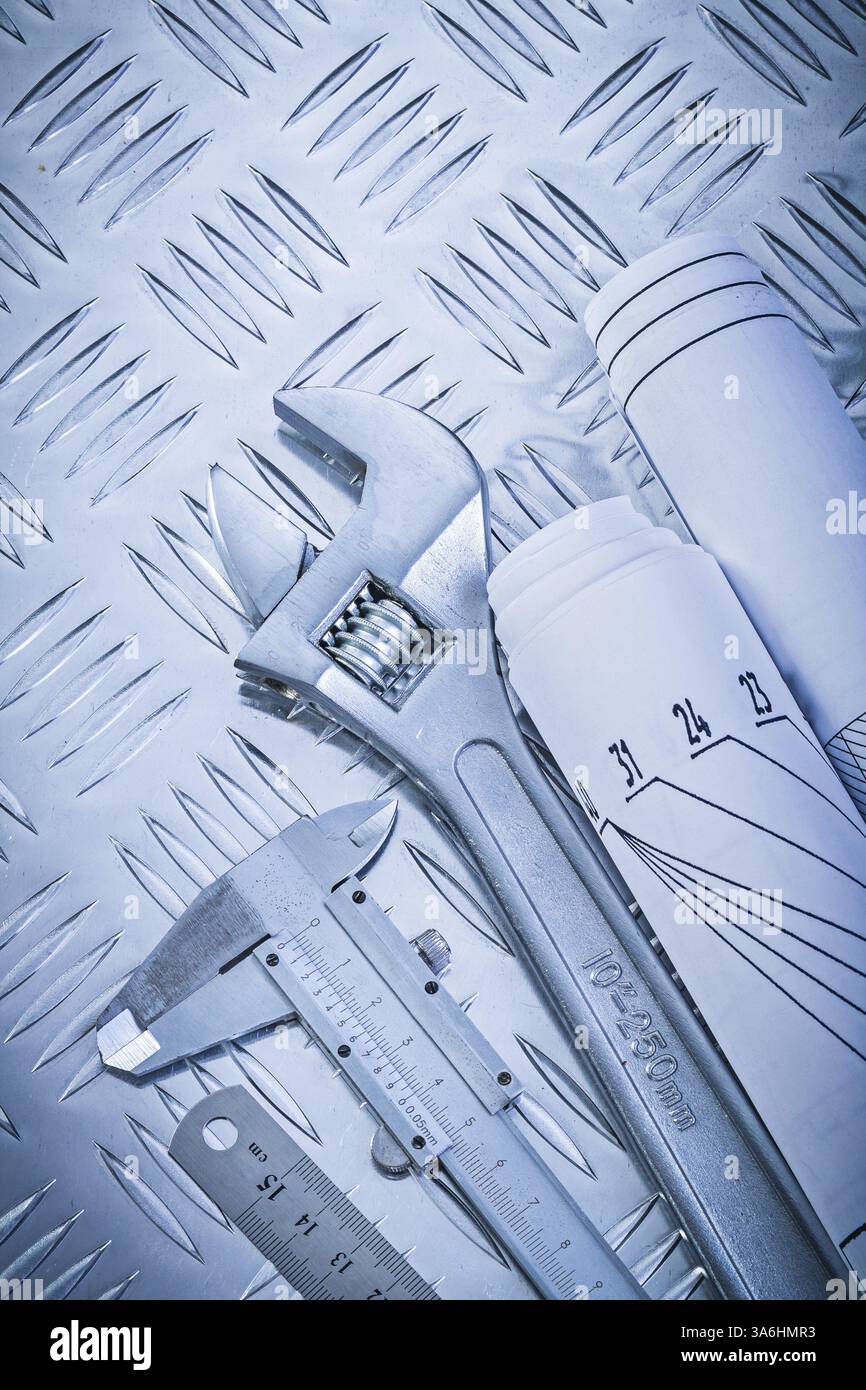 Engineering drawings slide caliper monkey spanner on corrugated metal ...