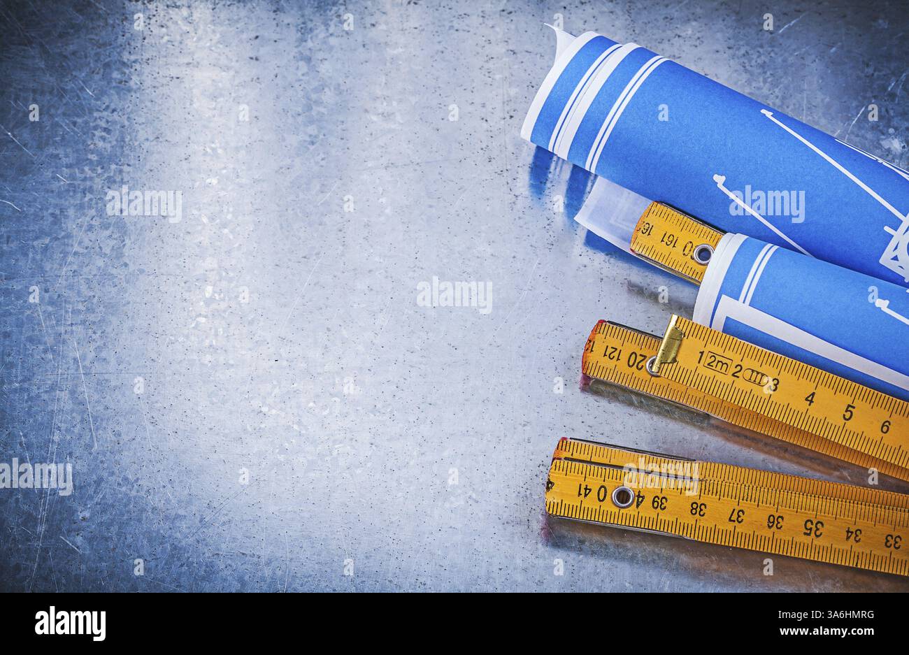 Copyspace of blue construction drawings wooden meter on metallic ...