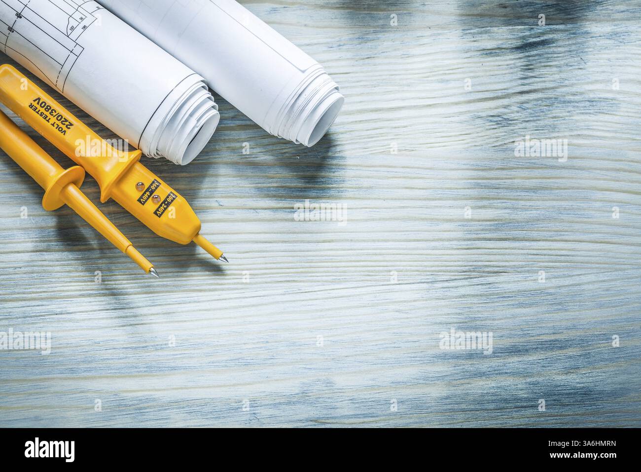 Electric tester engineering drawings on wooden board electricity ...