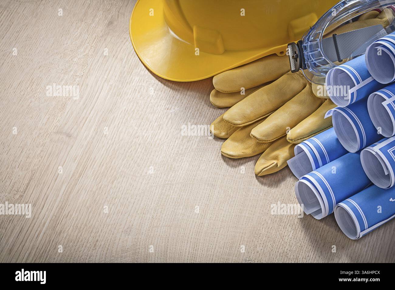 Set of building helmet protective gloves spectacles blueprints on ...