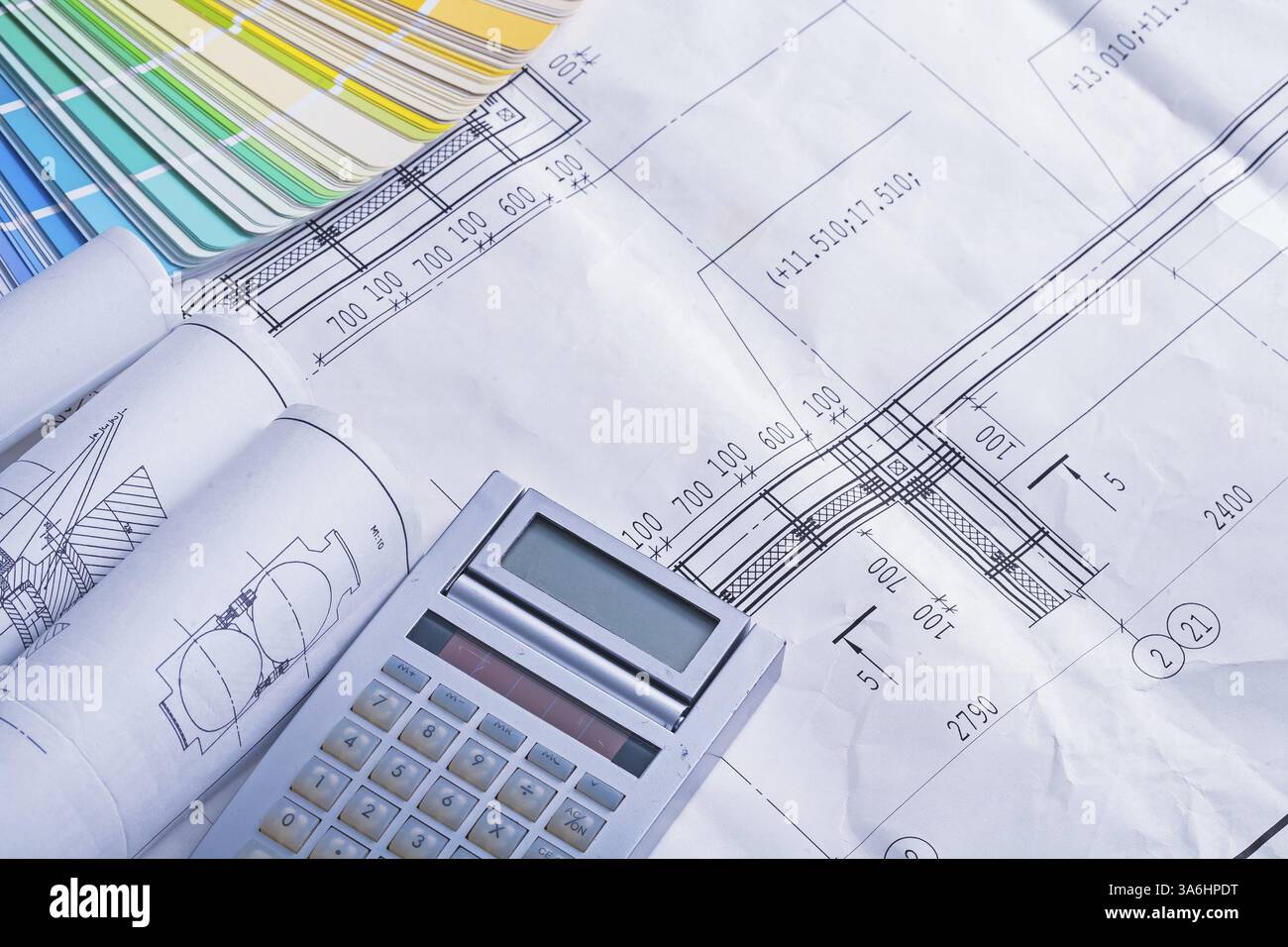 Calculator rolled blueprints color palette Stock Photo - Alamy