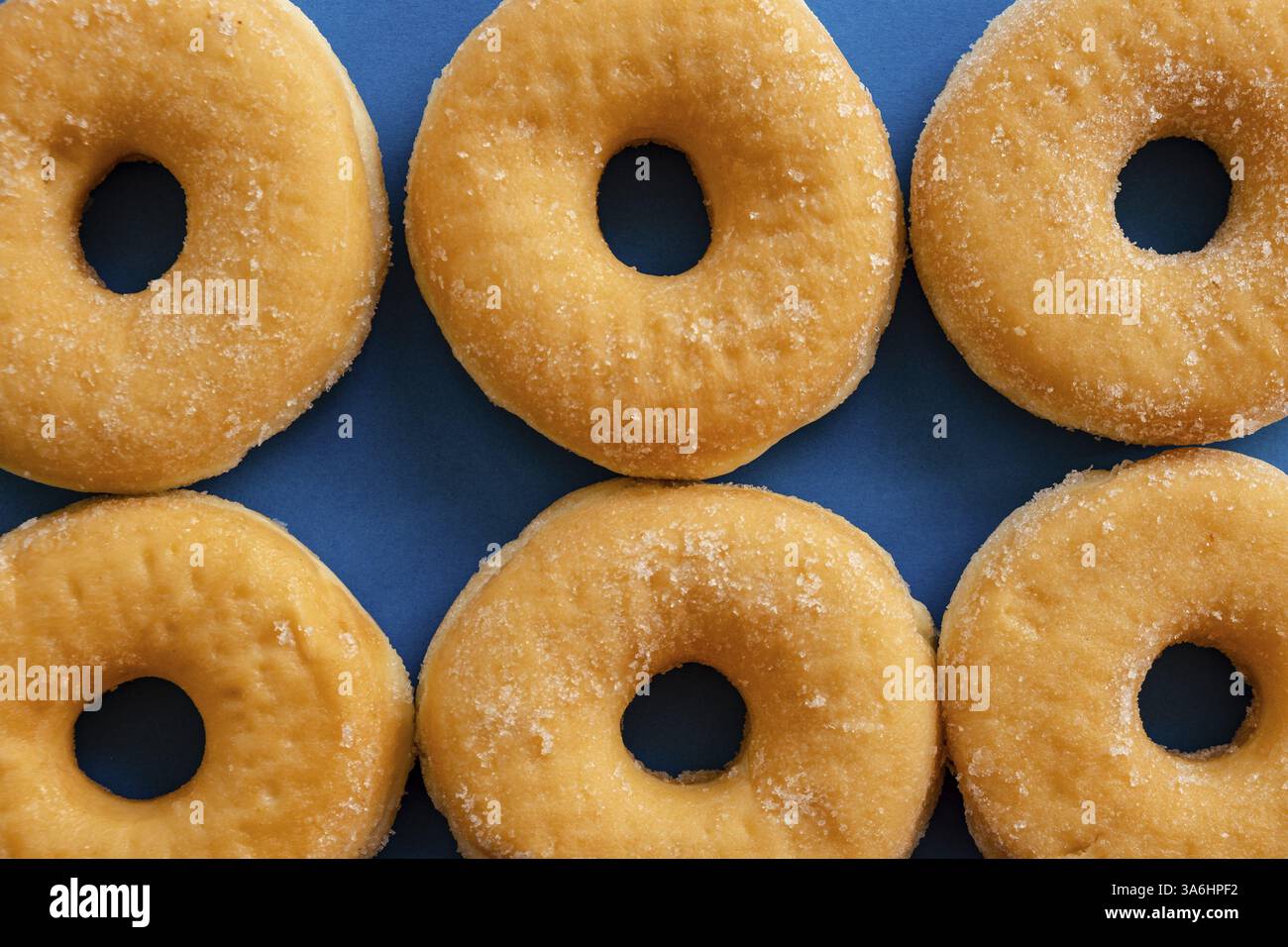 Six doughnuts on blue background Stock Photo - Alamy
