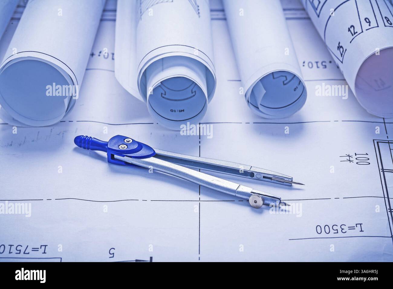 Compass and rolled up bluprints Stock Photo - Alamy