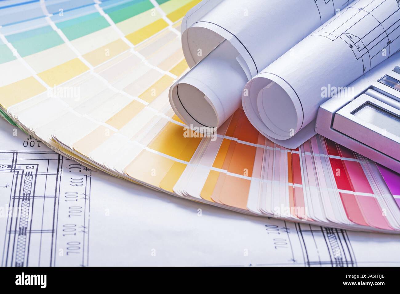 Rolled blueprints on color palette Stock Photo - Alamy