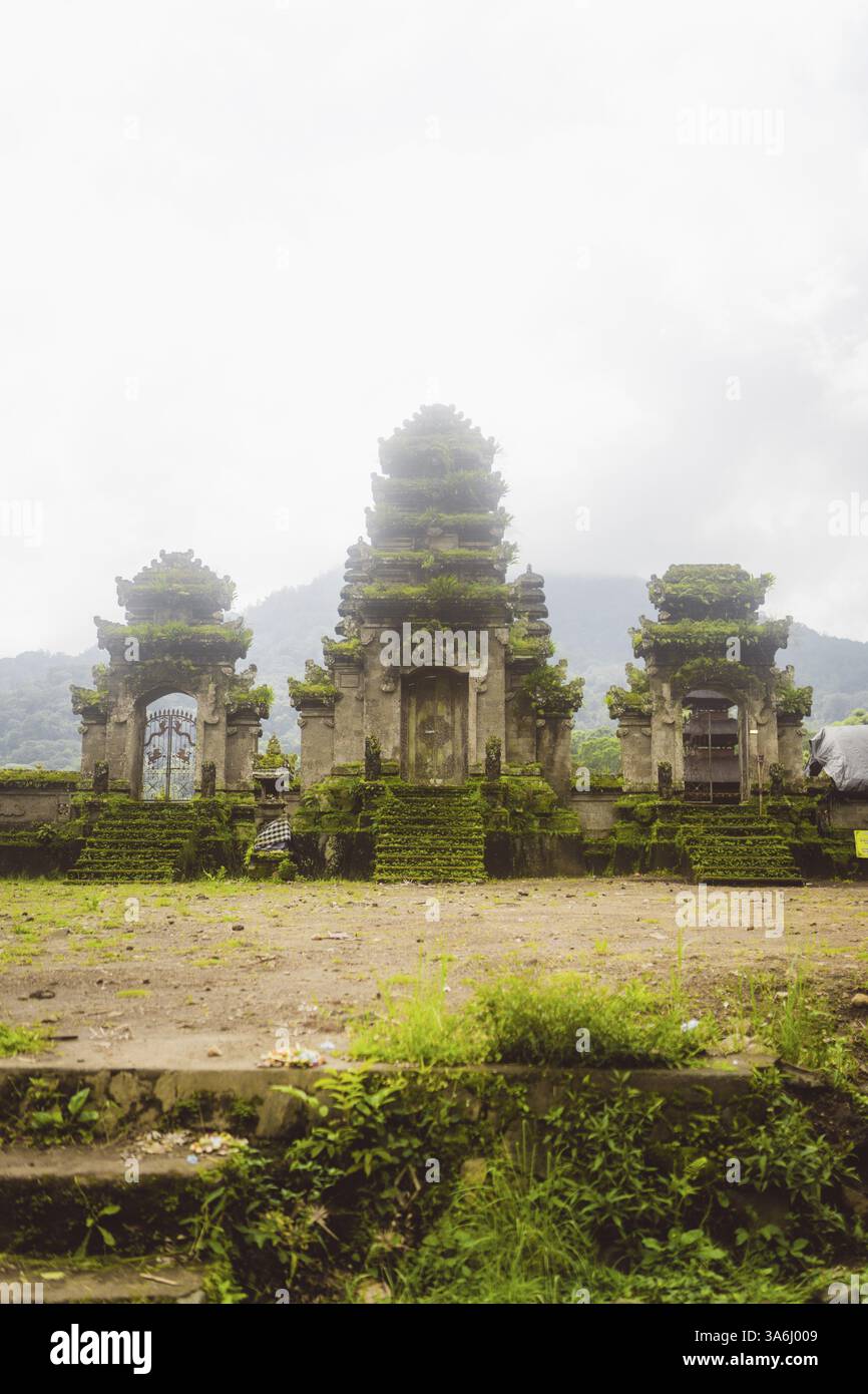 Old temple with moss-covered Tor tor and natural scenery under a cloudy ...