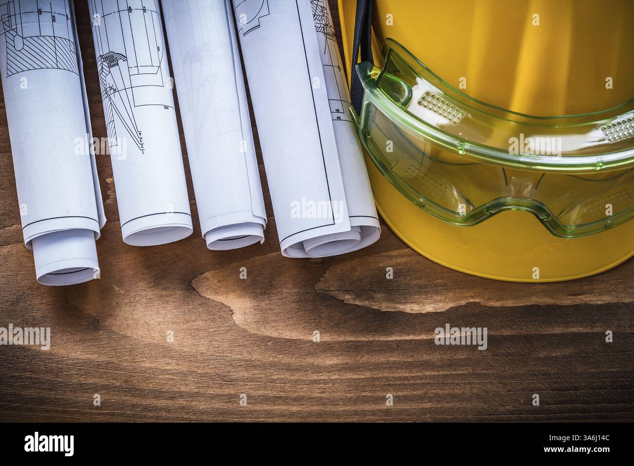 Goggles construction plans and hard hat on brown wood board Stock Photo ...