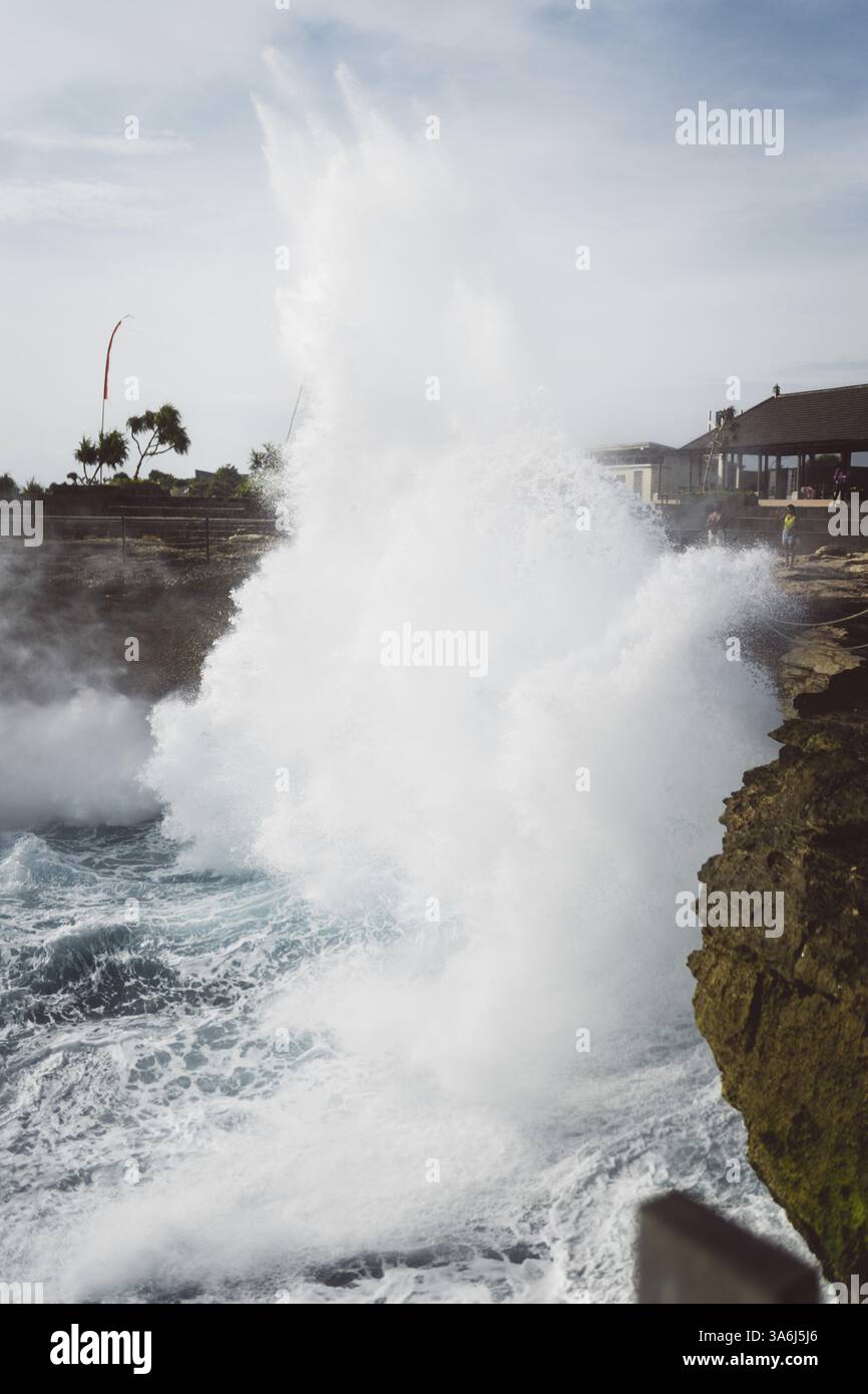 High waves crash with full force against the coast and splash up high ...