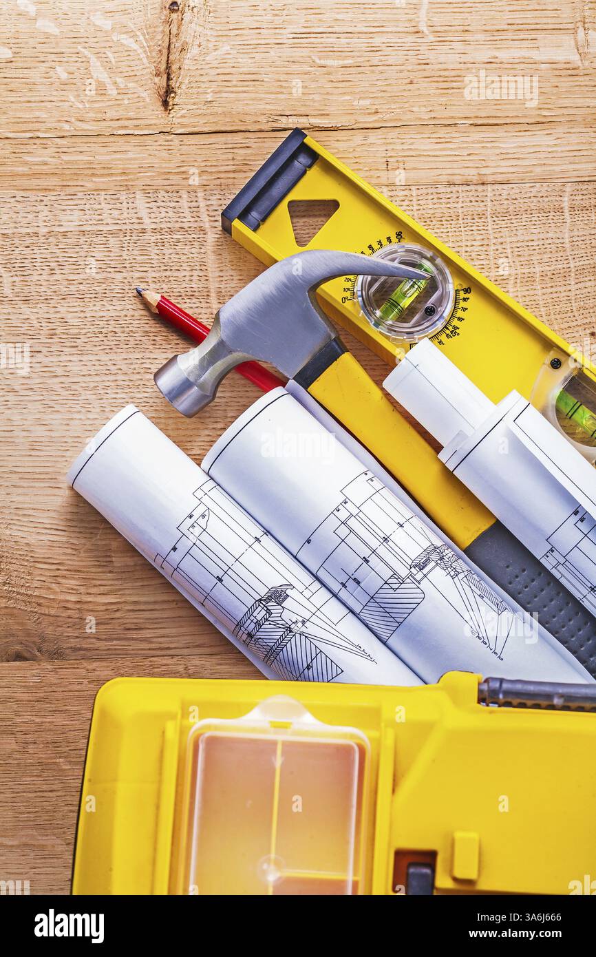 Rolled blueprints hammer level pencil toolbox on wooden board Stock ...
