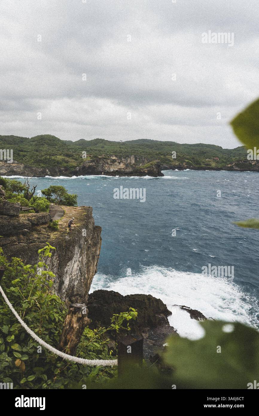 Coastal landscape with green cliffs and strong waves, Nusa Penida ...