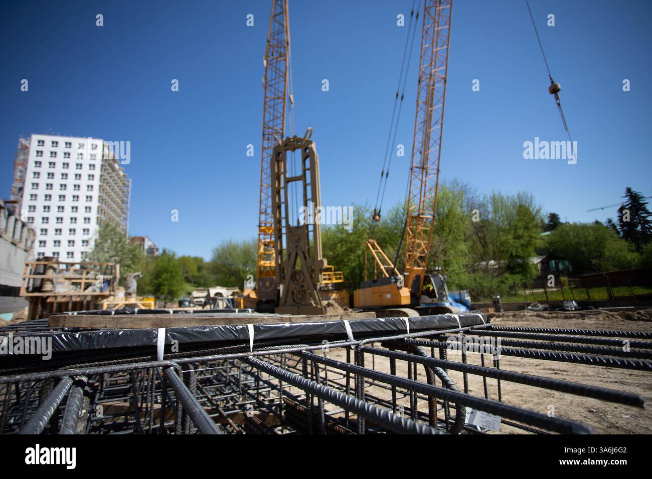A bustling Construction Site featuring Heavy Machinery and Steel ...