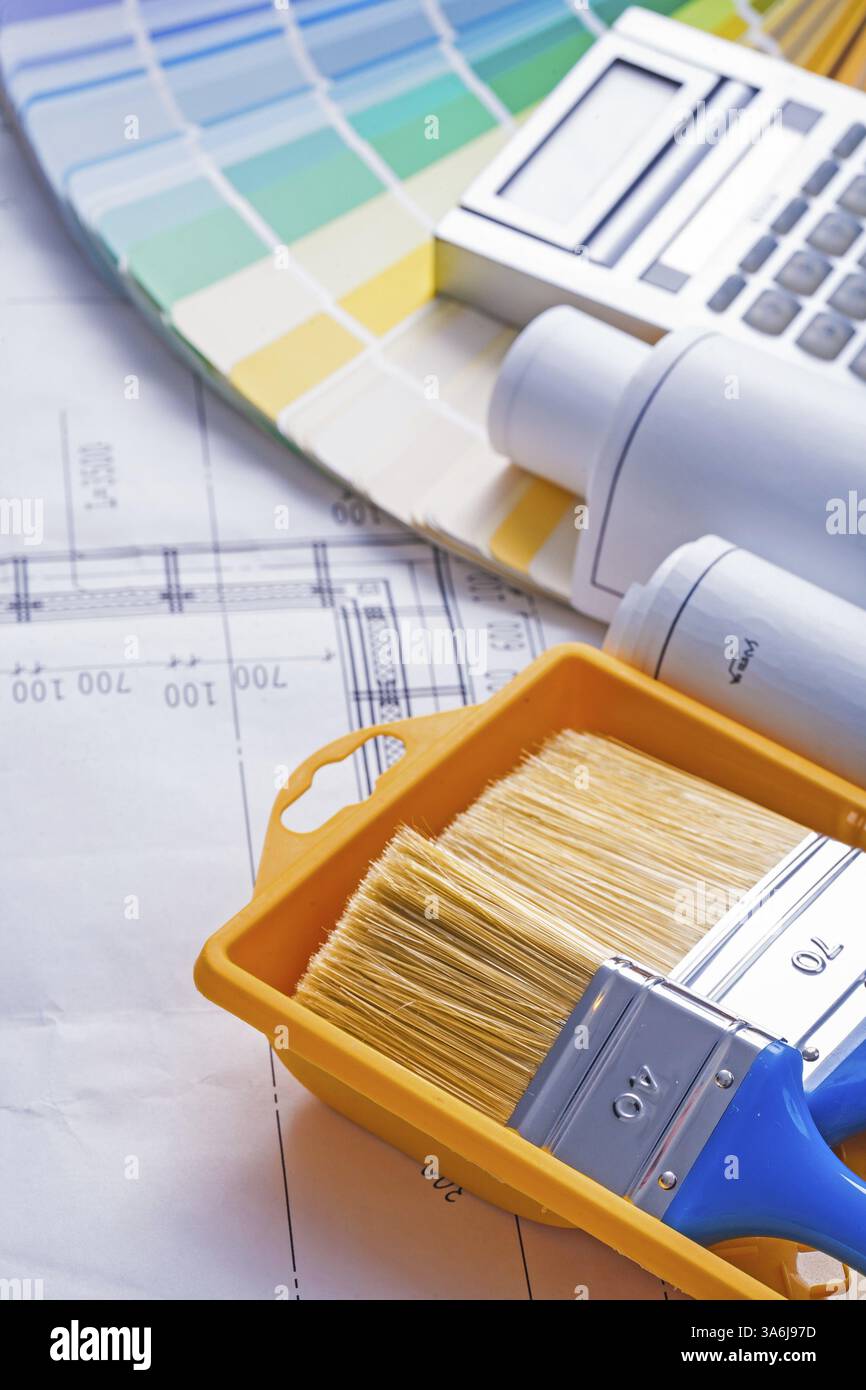 Brushes in paintcan blueprints calculator color palette Stock Photo - Alamy
