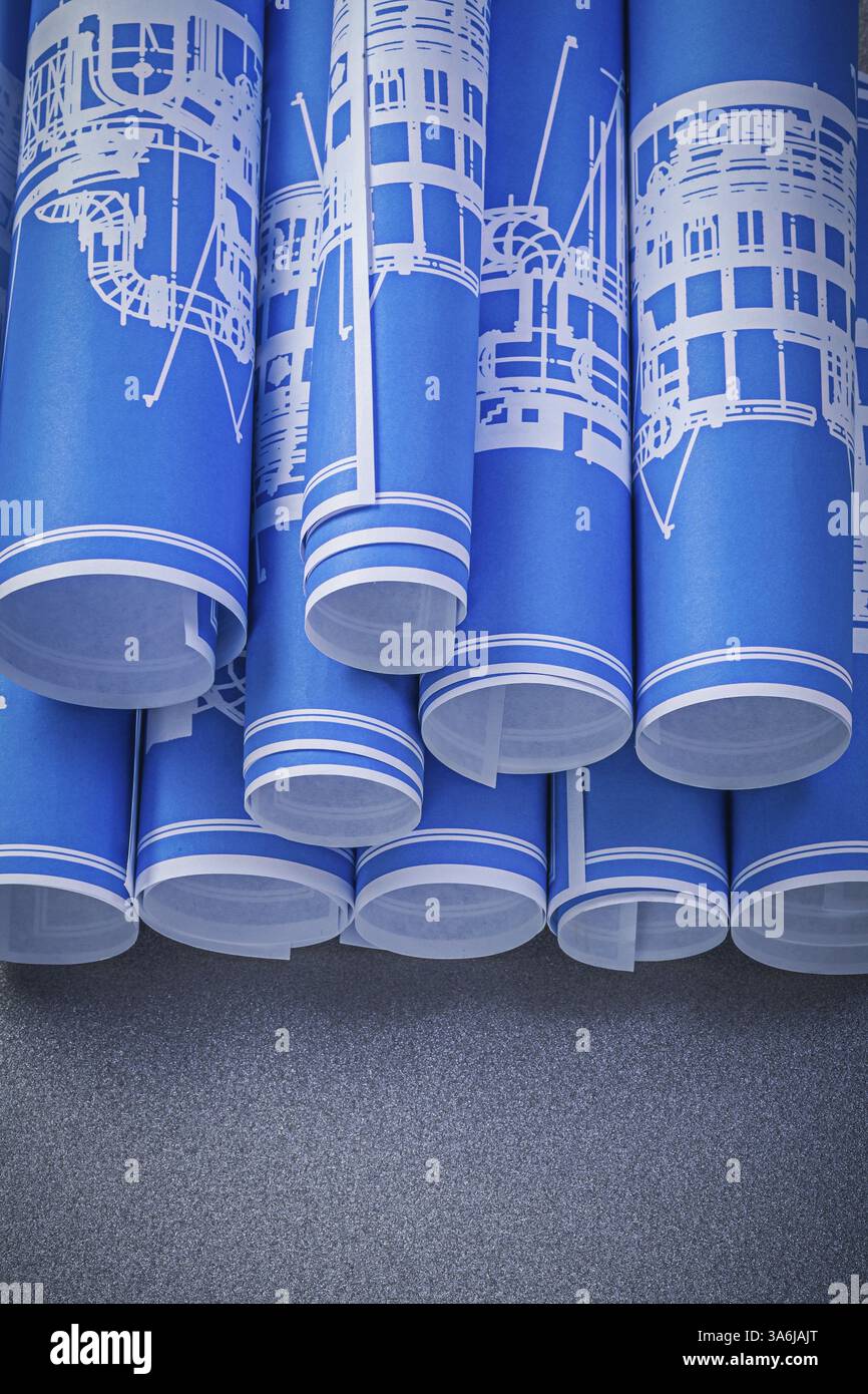 Set of blue rolled engineering drawings on grey background construction ...