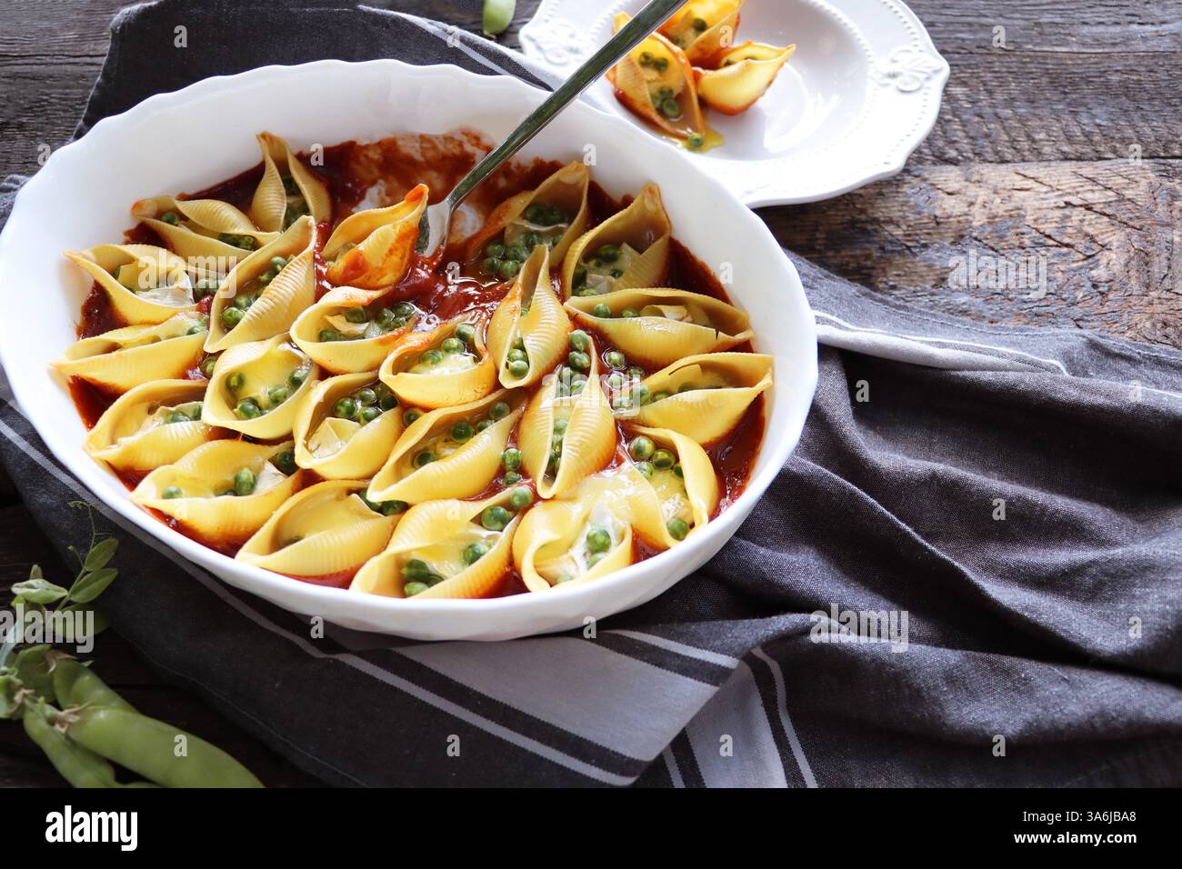 Stuffed Shells with Peas and Cheese in Tomato Sauce Stock Photo - Alamy