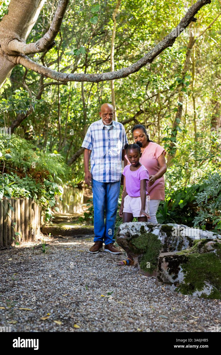 Exploring nature trail, grandparents and child spending time together ...
