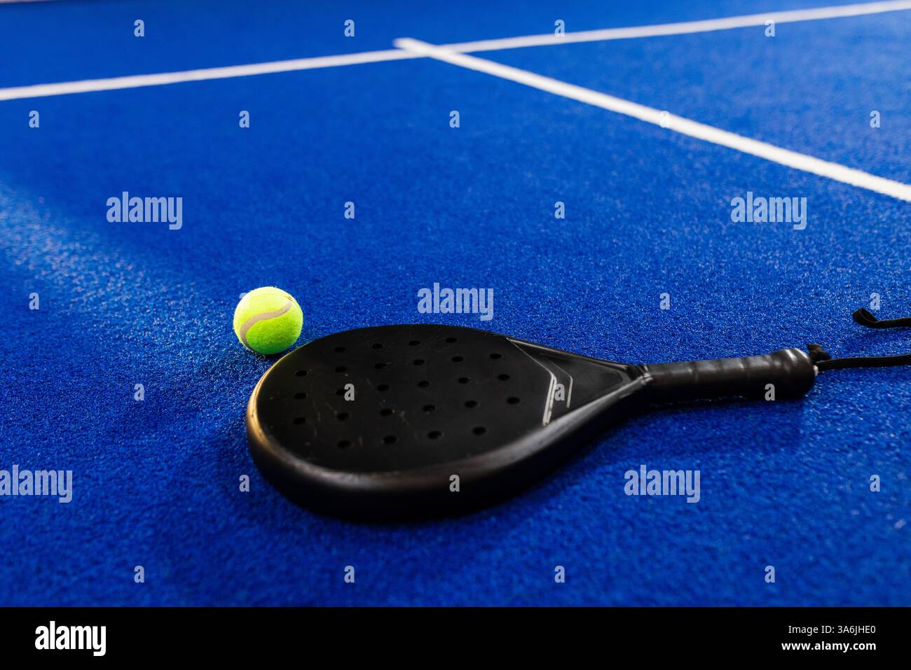 Padel racket and ball resting on blue court, ready for action Stock ...